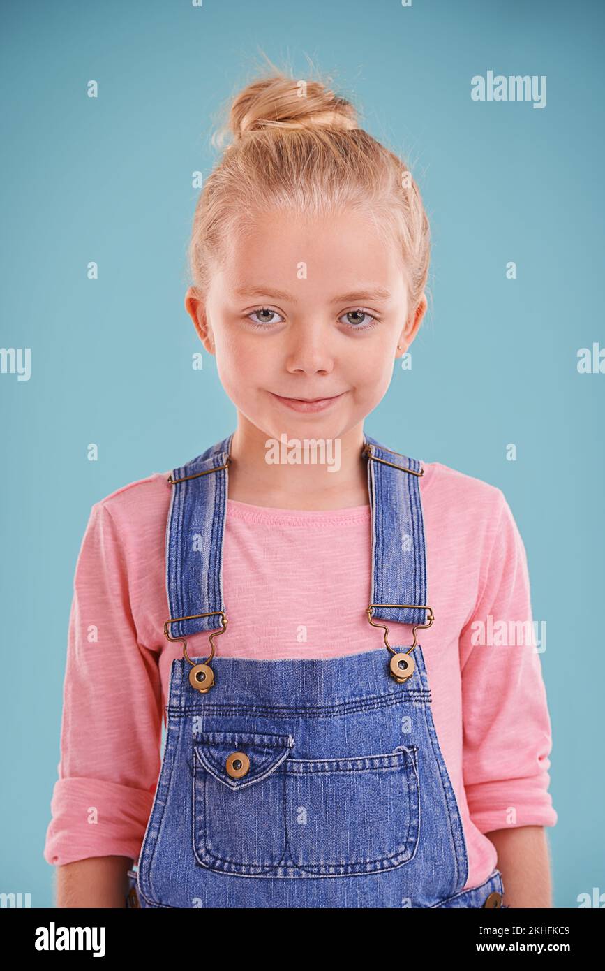 Beyond cute. a cute blonde girl isolated on a blue background Stock ...