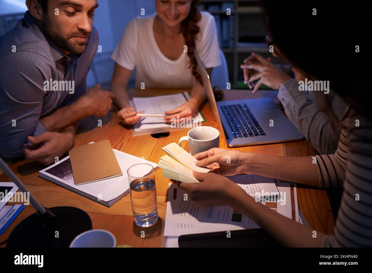 Take a look at these. coworkers working into the evening in the office ...