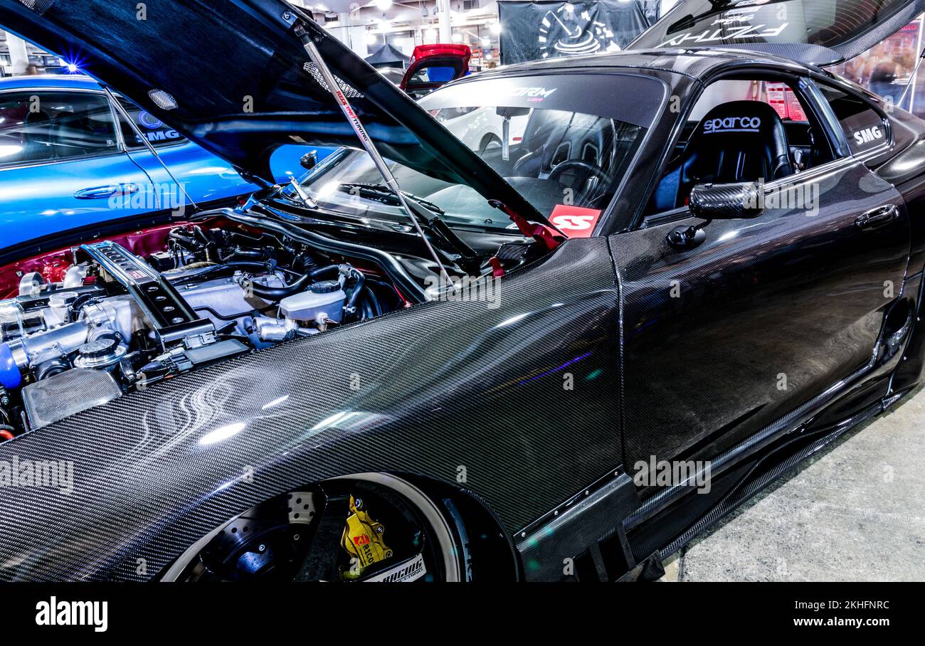 A side view of a gray Toyota Supra with an open hood at Hot Import Car ...