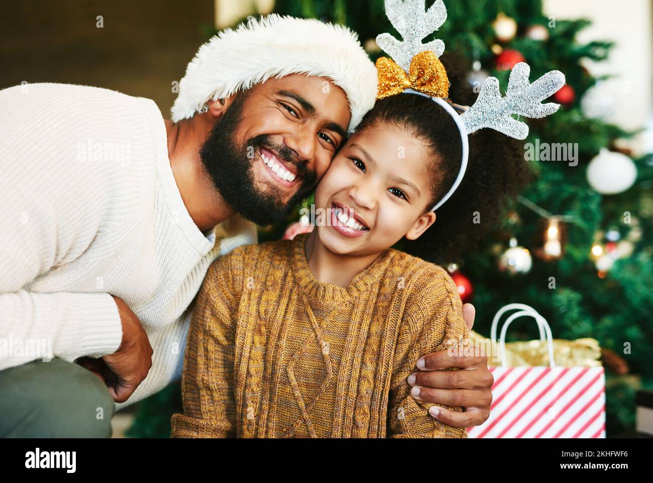 Chirtsmas, family and love with a father giving child a hug for ...