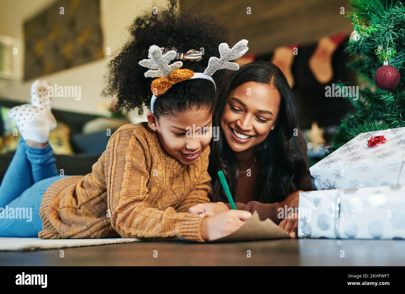 Christmas, family and writing with a mother and daughter sending a ...