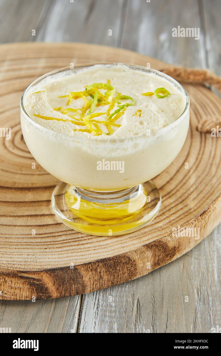 Lemon mousse, lovely French recipe dessert on wooden background. Close ...