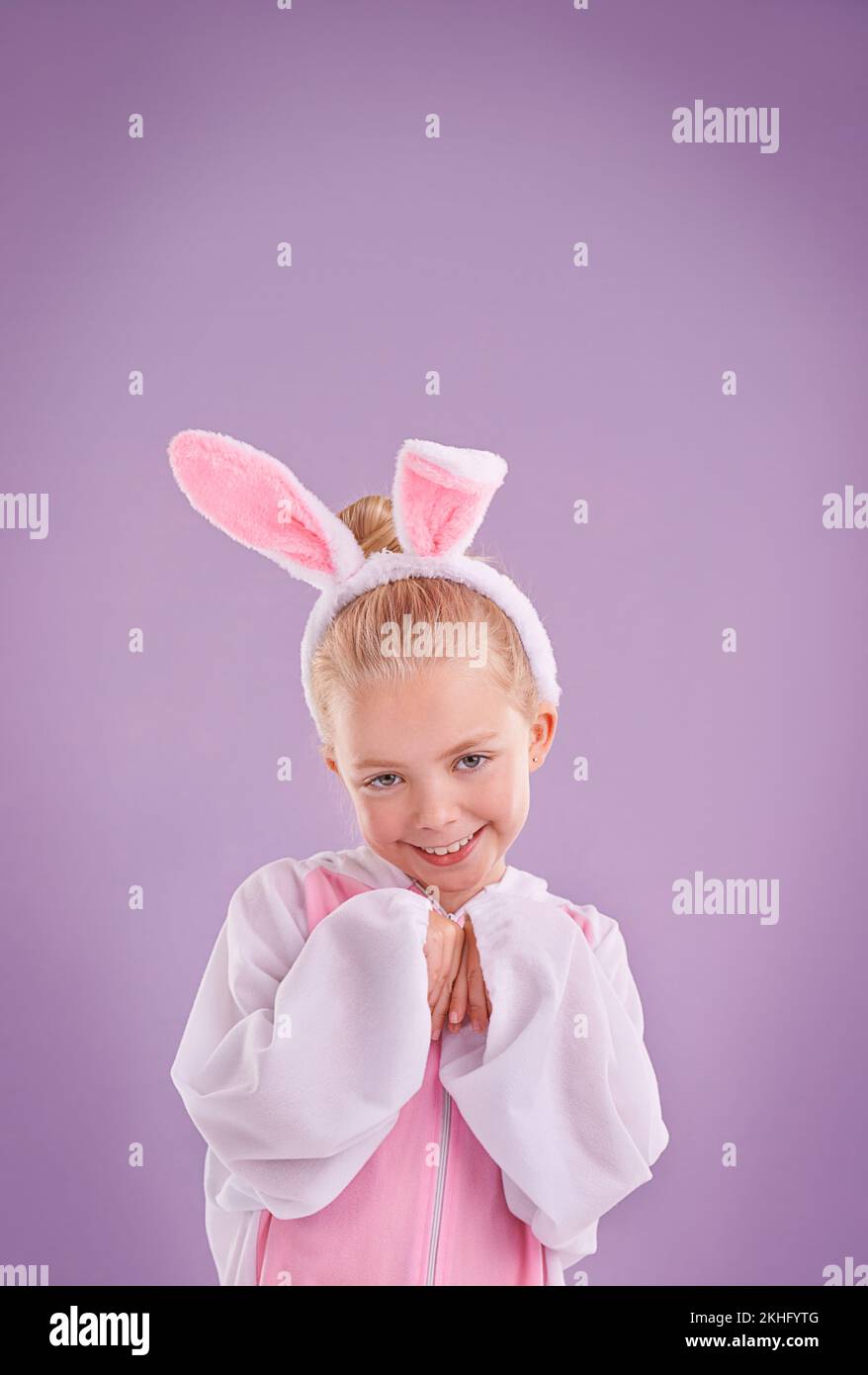 Funny bunny. Studio shot of a cute little girl dressed up in a bunny ...