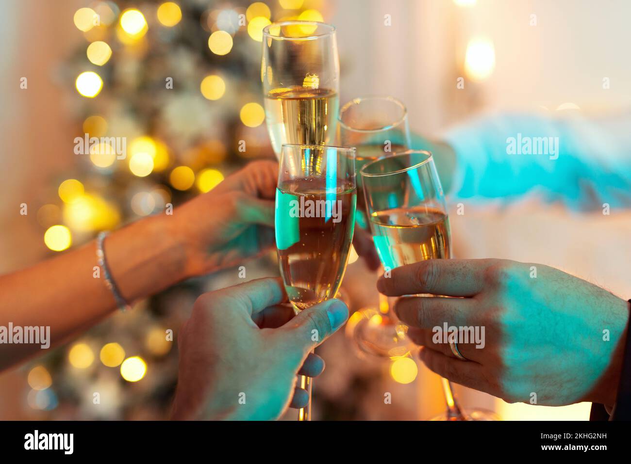 Close up shot of a group of people toasting glasses filled with ...