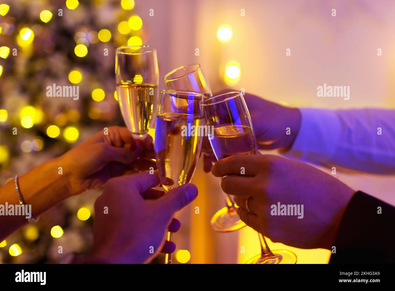 Close up shot of a group of people toasting glasses filled with ...