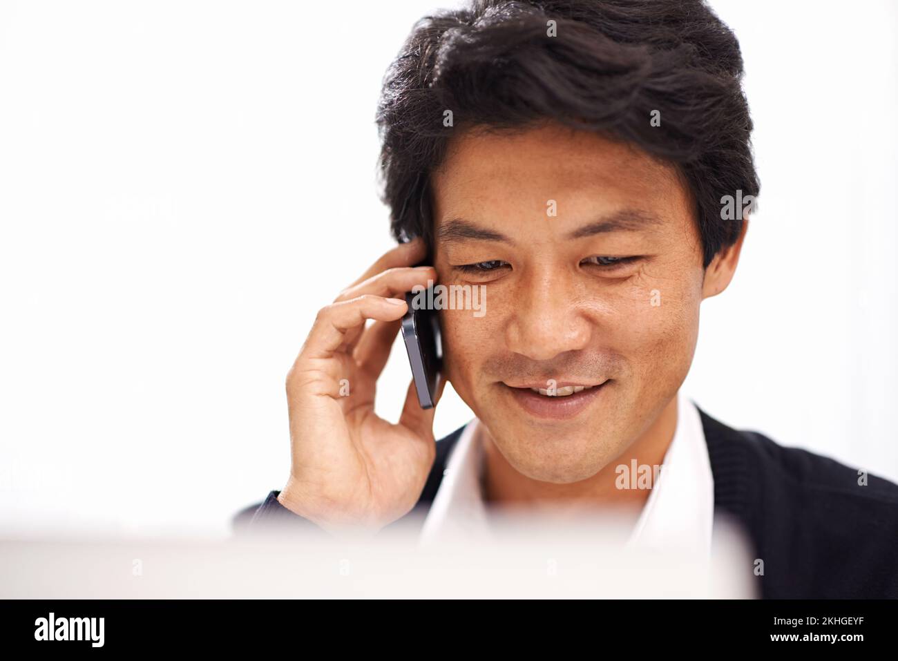Answering his clients questions with finesse. a handsome asian ...