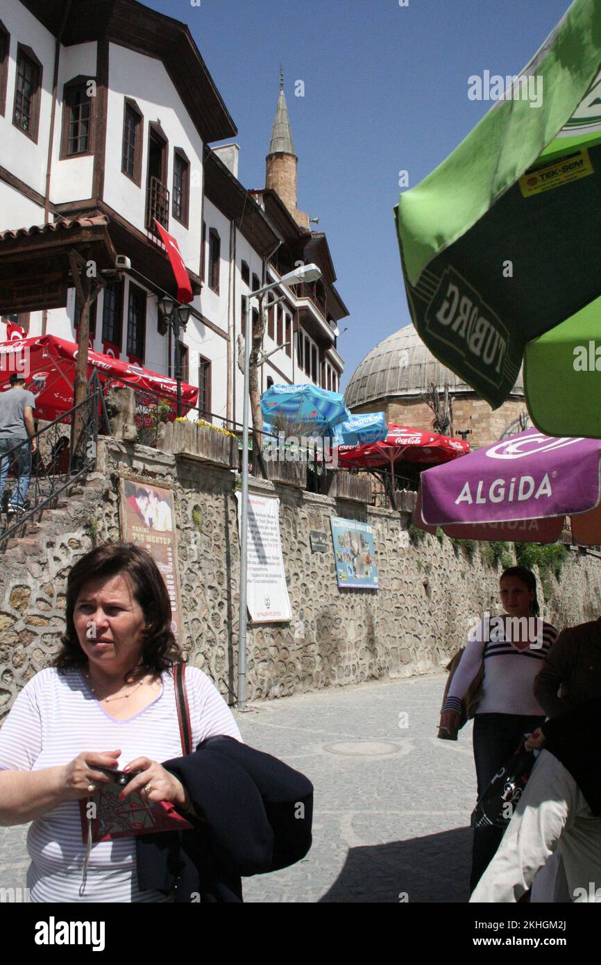 Street scene; main shopping street; Beypazari; Turkey; A woman walking ...