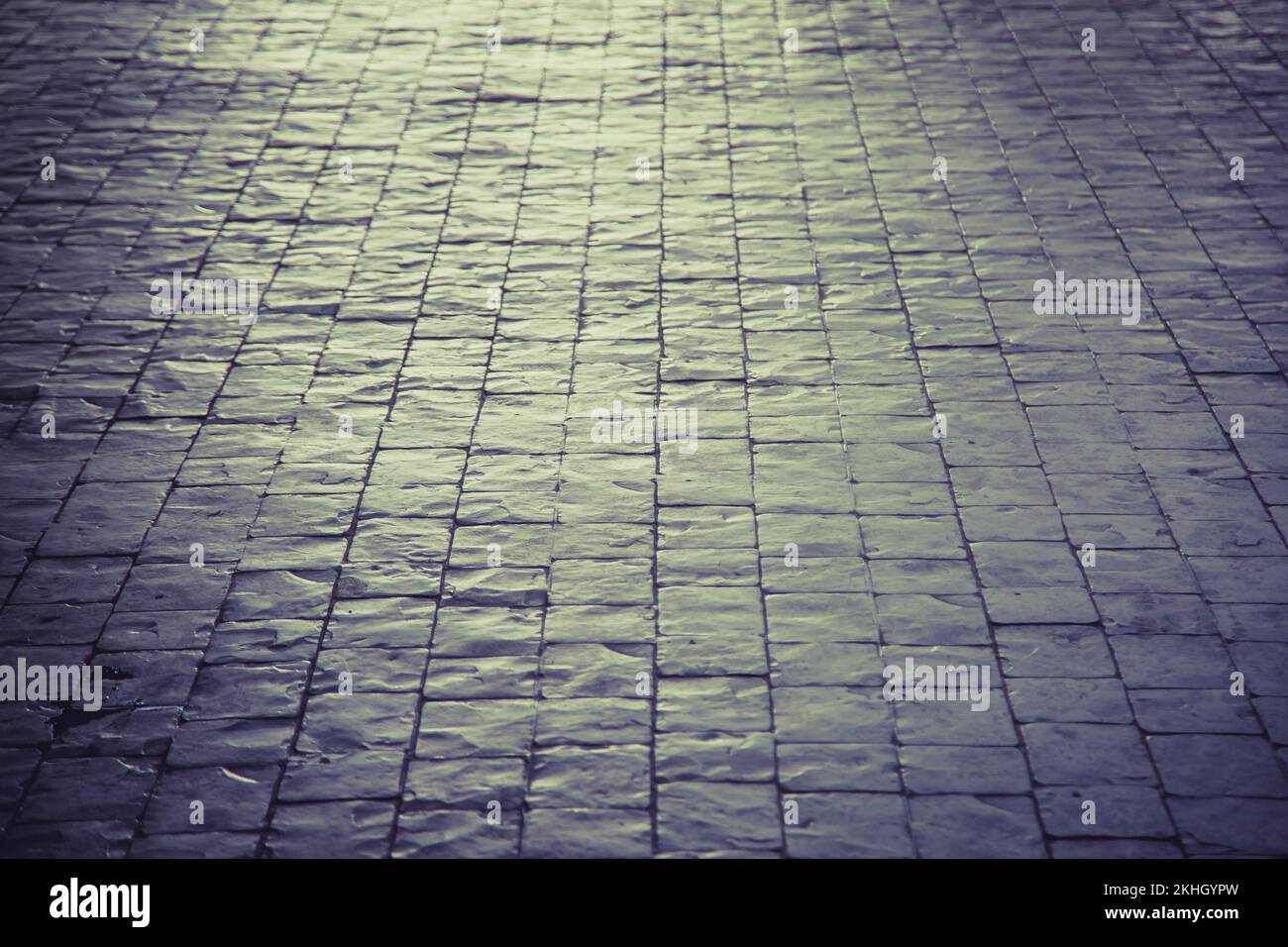Road made of small pieces of old gray bright stone use for background ...