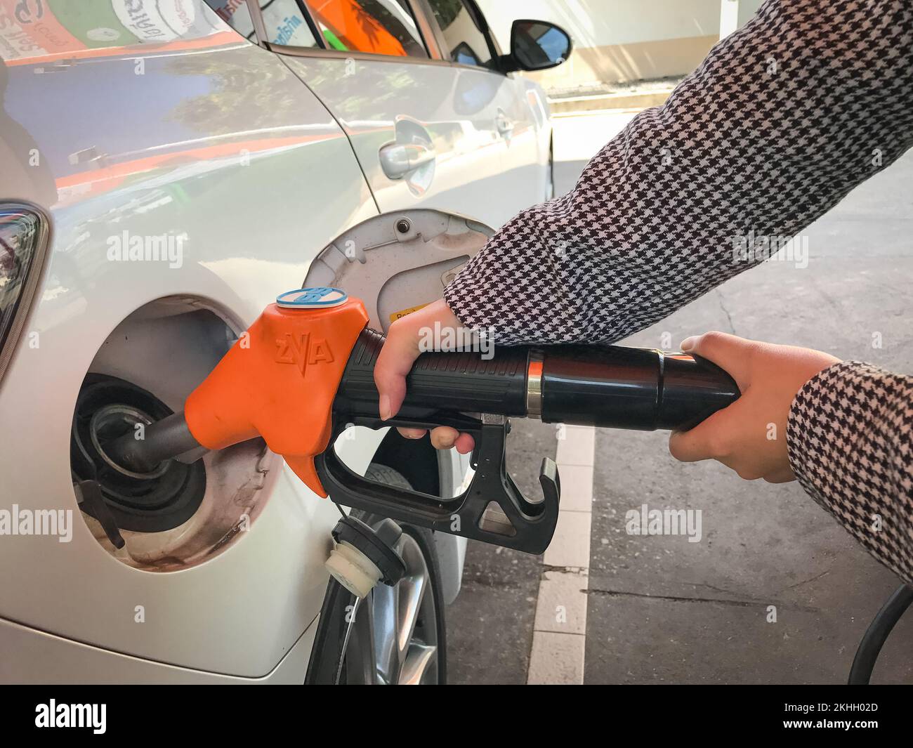 Woman refueling car at the gas station background Stock Photo - Alamy