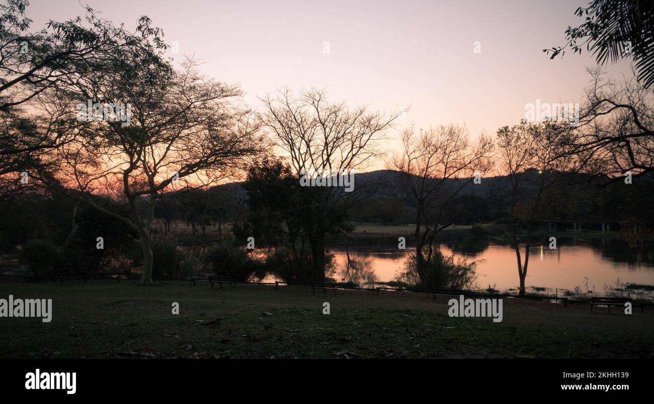 dusk, sunset, nightfall on a waterhole, water hole, watering hole in ...