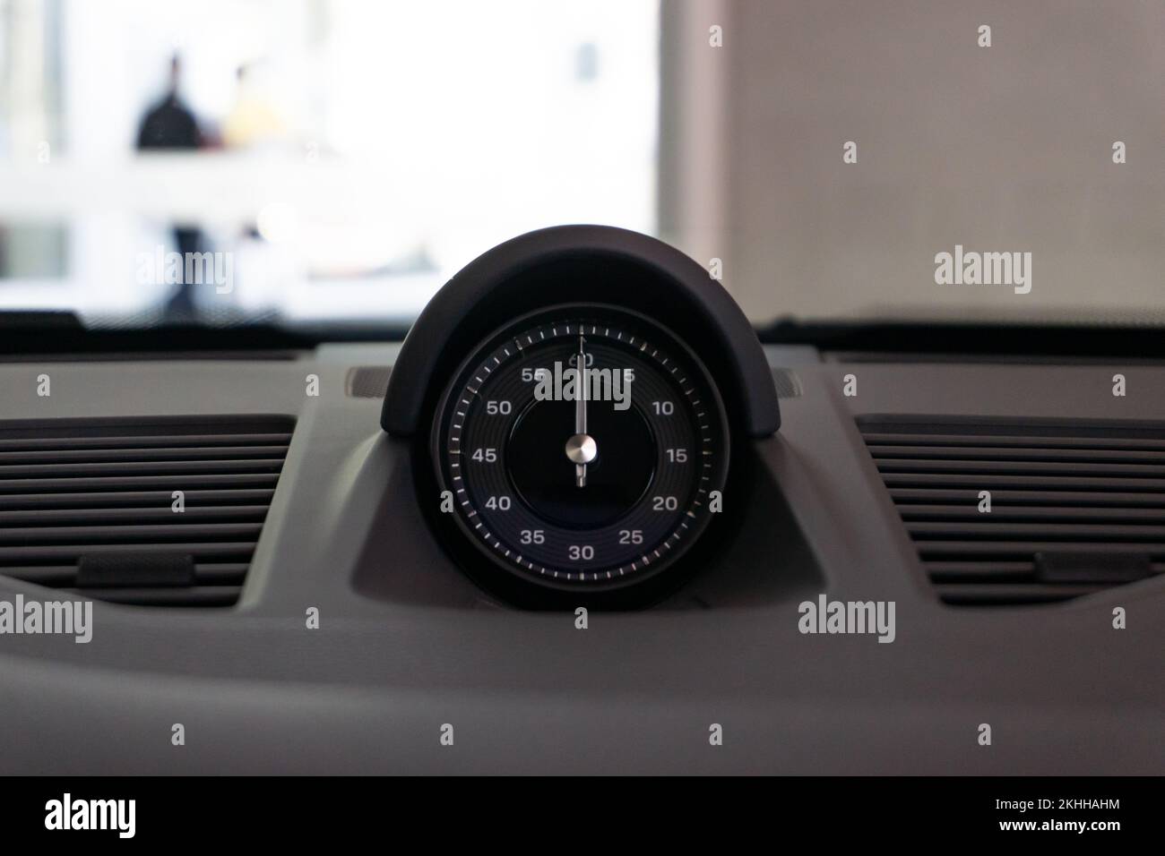 A closeup of a black dashboard clock on the Porsche 911 Sport Chrono ...