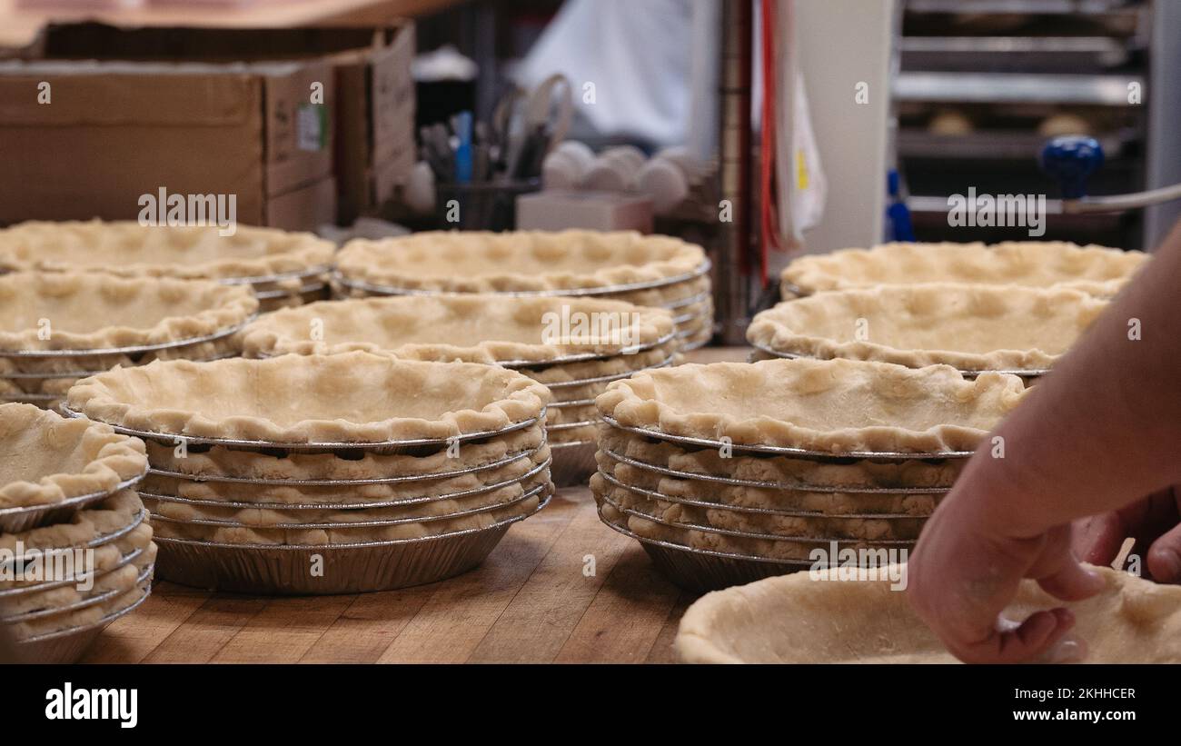 Pie shells stacked in columns in a small, professional bakery Stock ...