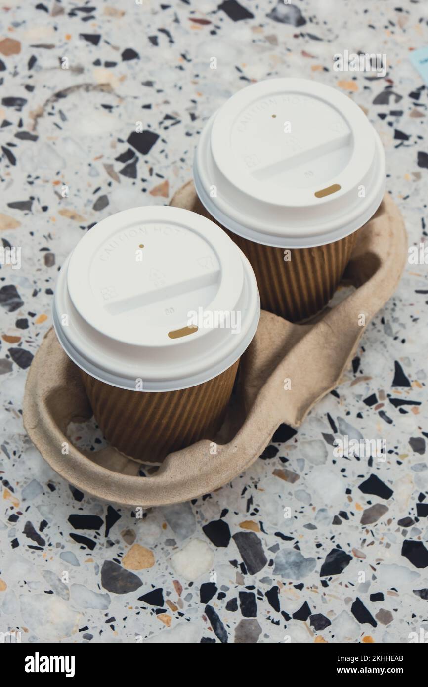 Two paper cups with lid for tea to go. Coffee take away on the table ...
