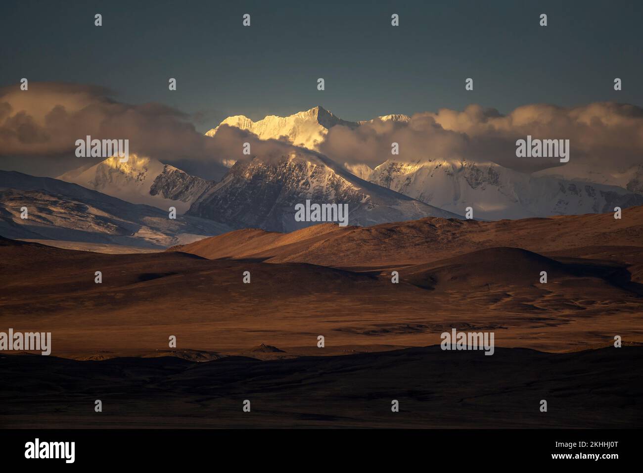 The scenic Kangchenjunga peak covered by floating clouds in the sky in ...