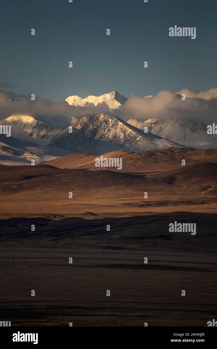 The scenic Kangchenjunga peak covered by floating clouds in the sky in ...