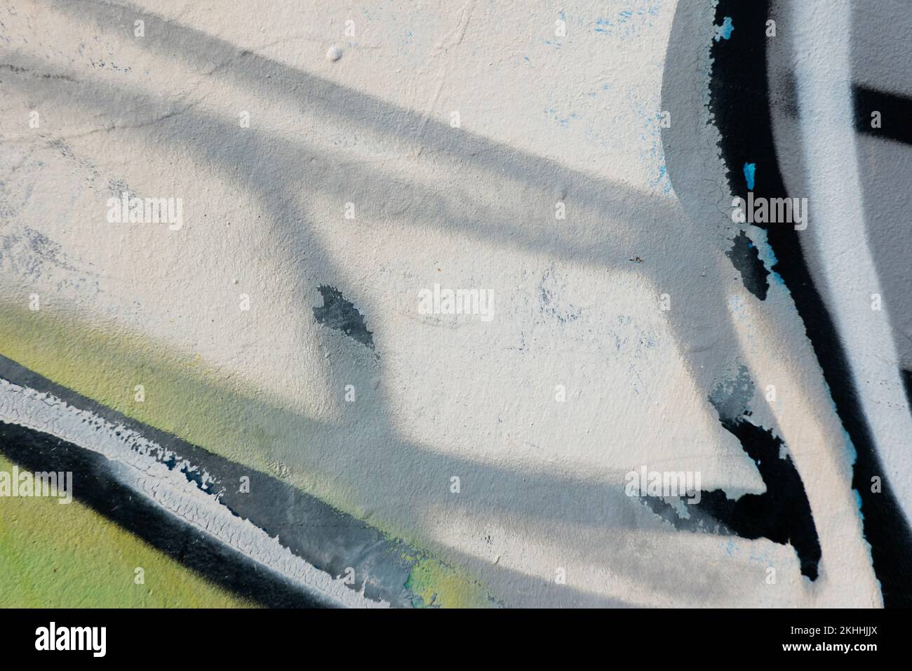 Fragment of old cracked plaster wall with graffiti painting. Part of ...