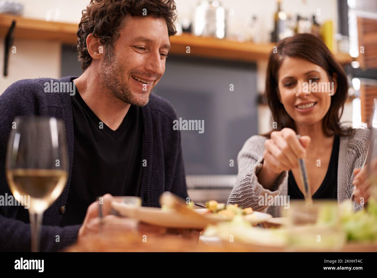 Happy occasions must involve food. a happy couple sitting down to ...