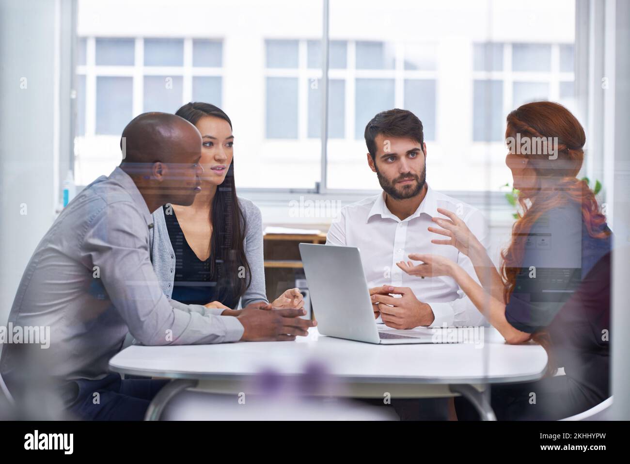 Serious brainstorming. A group of businesspeople having a meeting in a ...