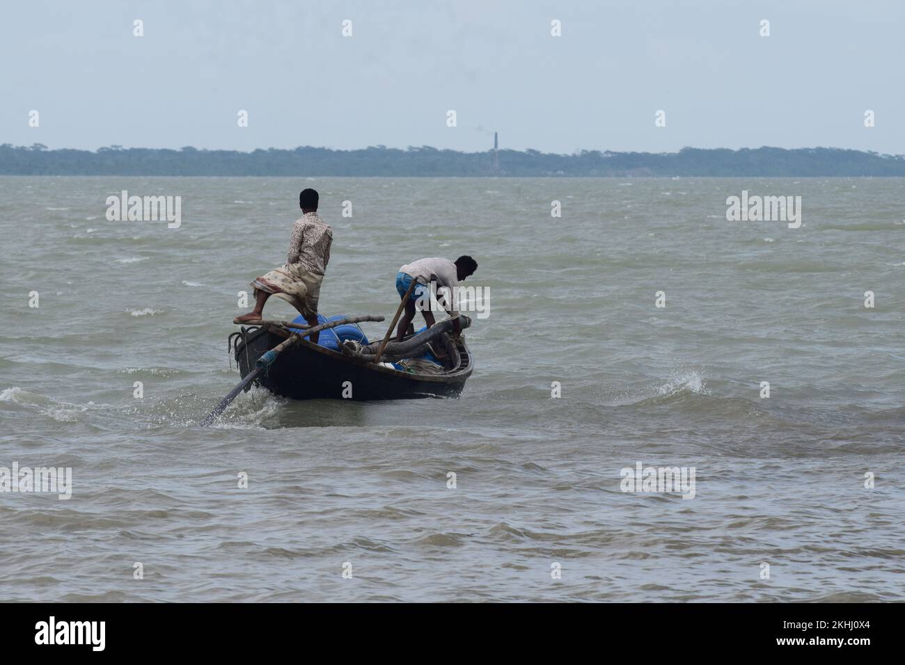 Fishermen going to river to catch fishes with small boat Stock Photo ...