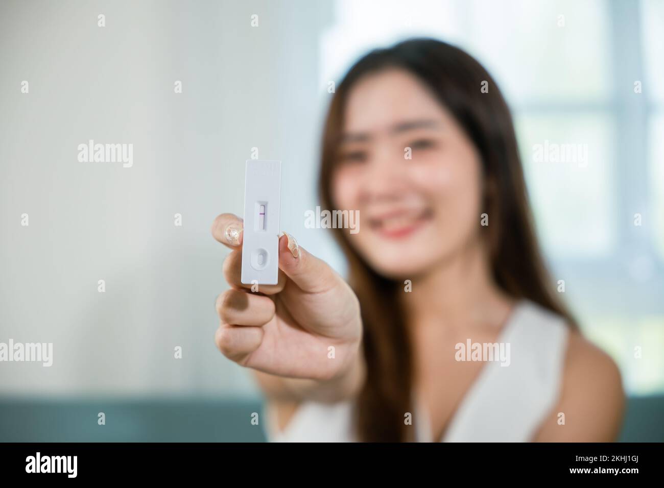 Close up woman showing rapid antigen test kit for selftest with ...