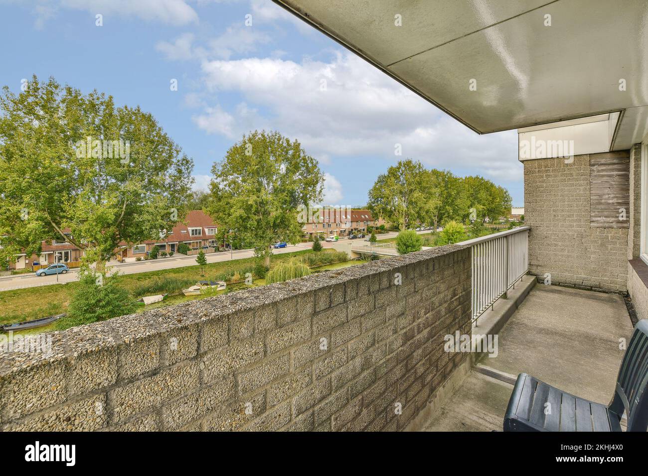 Panoramic view of old brick buildings with trees from small balcony ...