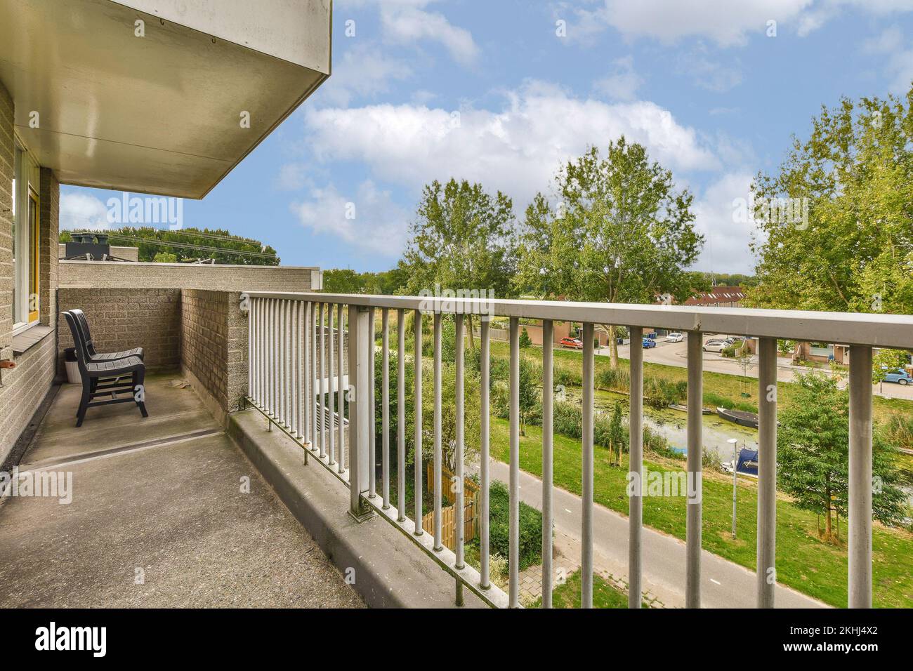 Panoramic view of old brick buildings with trees from small balcony ...