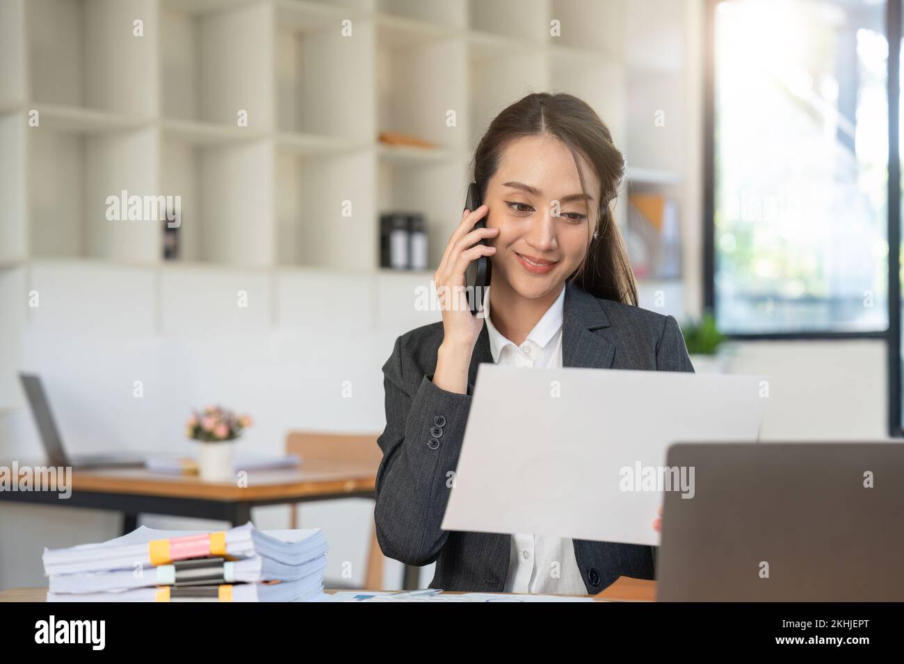 Business asian woman using smartphone for do math finance on wooden ...