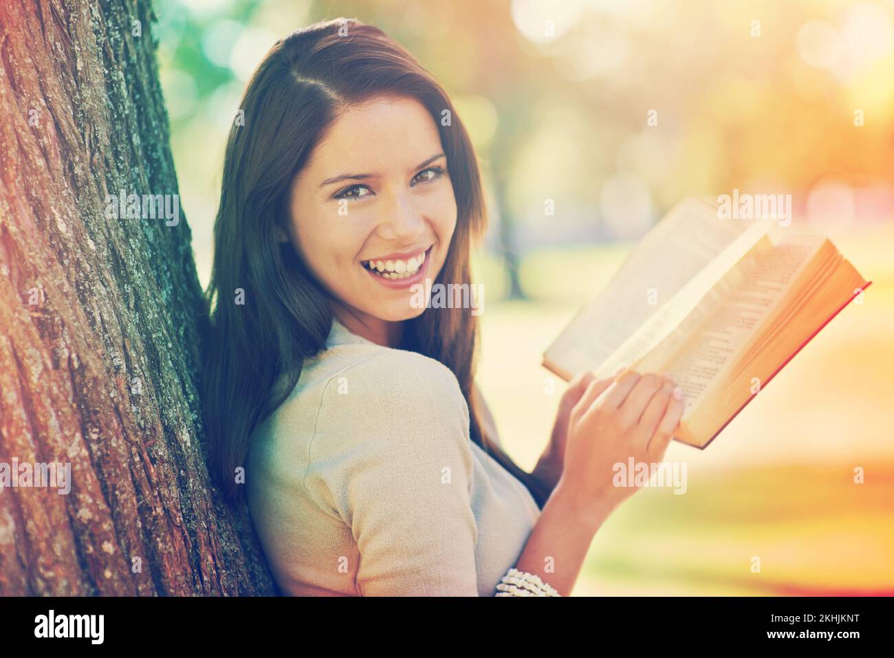 Utter bliss. Portrait of a beautiful young woman reading a book while ...