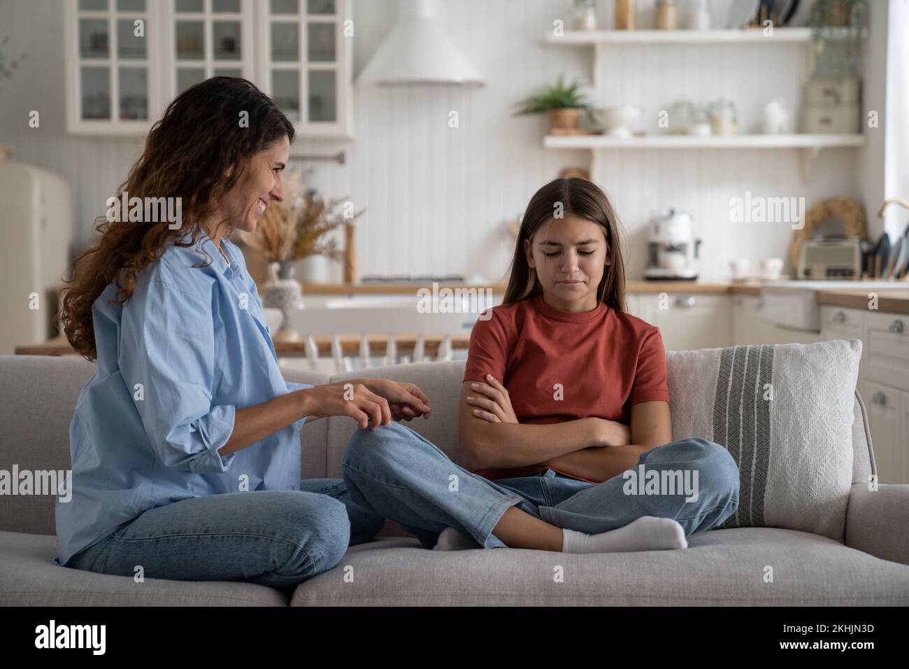 Positive young loving woman mother trying to cheer up angry offended ...