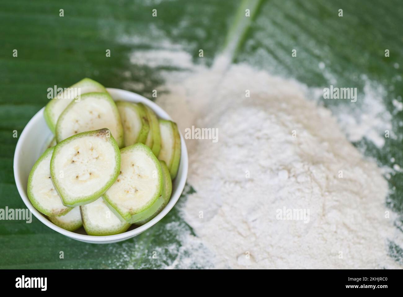banana powder on bowl and raw banana - banana fruit on leaf background ...