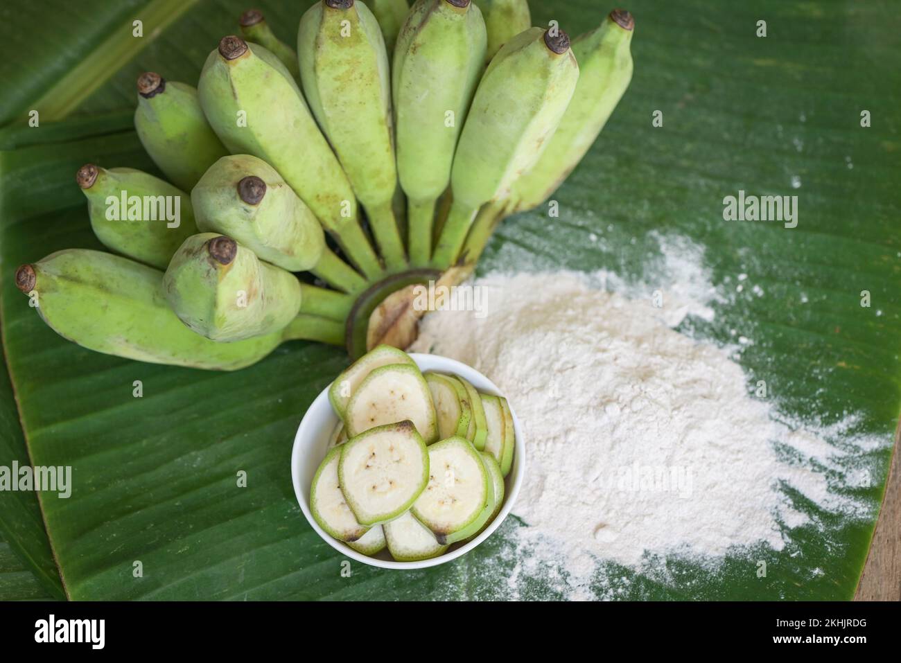 banana powder on bowl and raw banana - banana fruit on leaf background ...