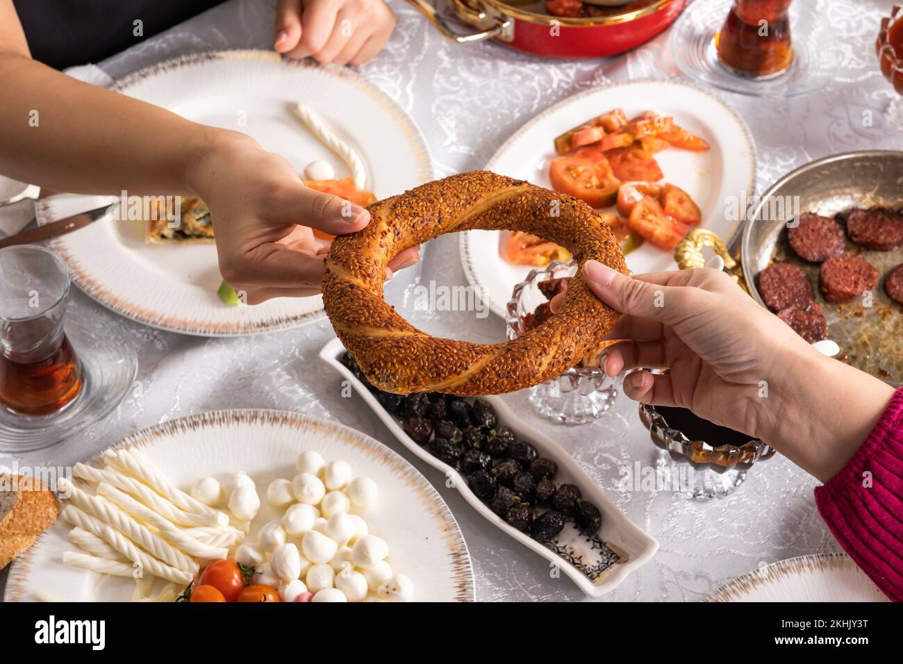 Turkish bagel, friends sharing Turkish bagel called simit on breakfast ...