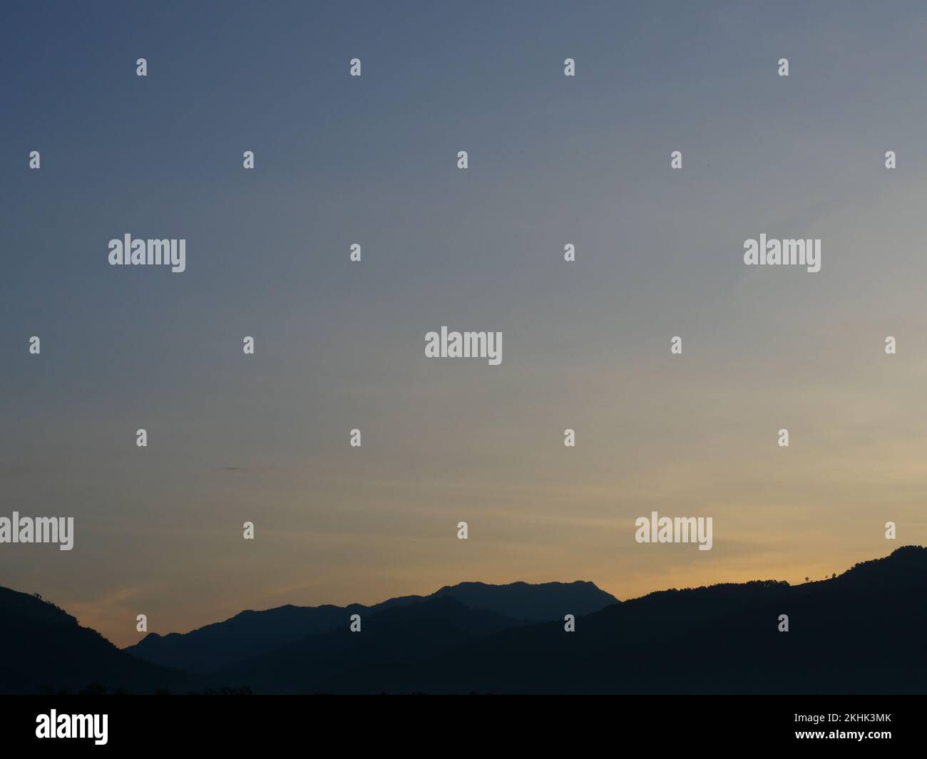 Silhouette of mountain with blue sky at sunrise ,Horizon began to turn ...
