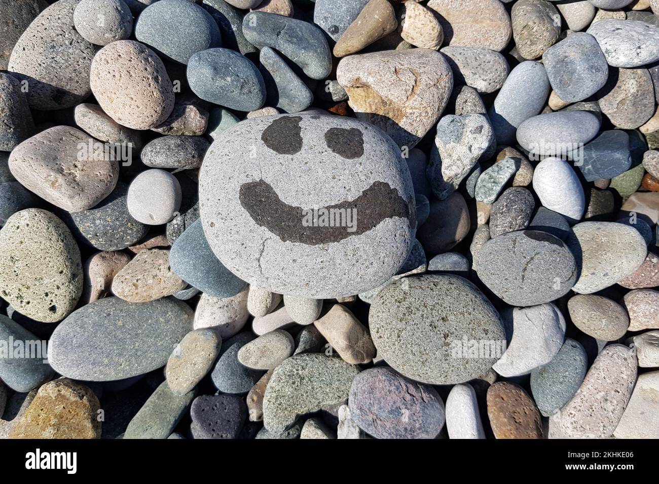 Closeup of grey pebbles on a beach with painting of smile Stock Photo ...