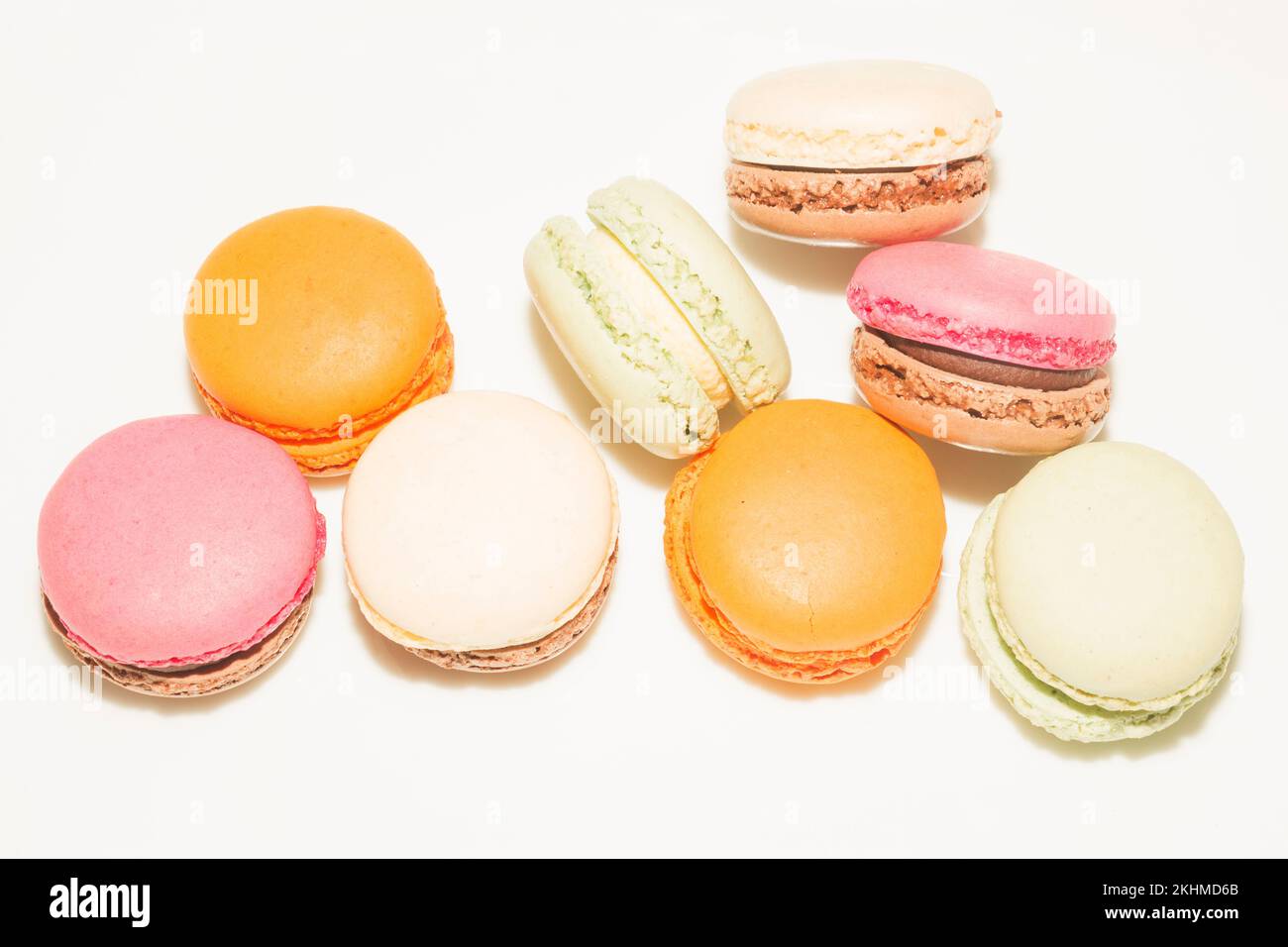 Delicious bright coloured macaroni on a white background. Traditional ...