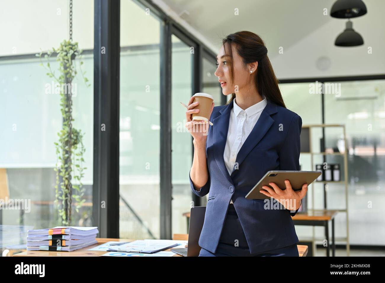 Beautiful and gorgeous millennial Asian businesswoman sipping coffee ...