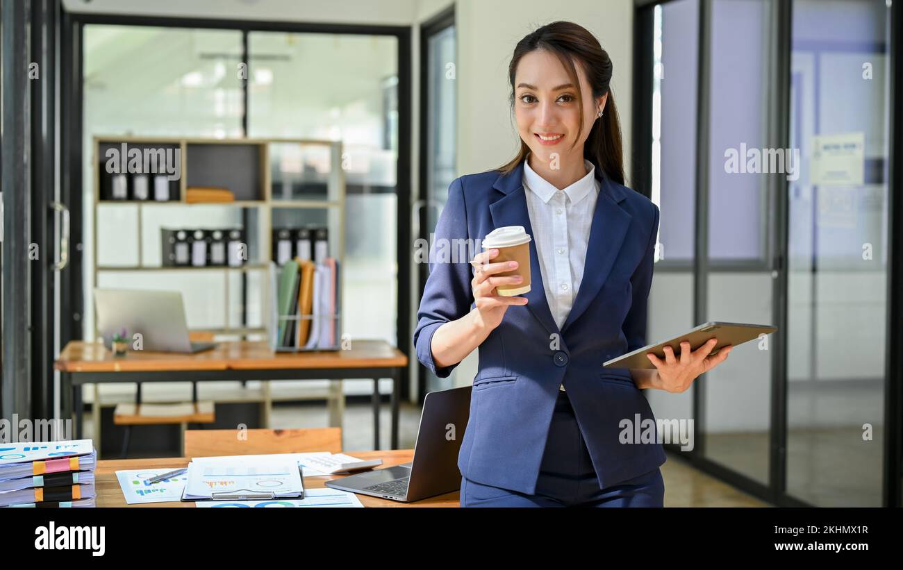 Beautiful millennial Asian businesswoman or female CEO in business suit ...