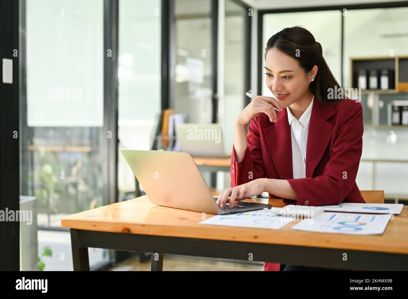 Charming and attractive young Asian businesswoman or female sales ...