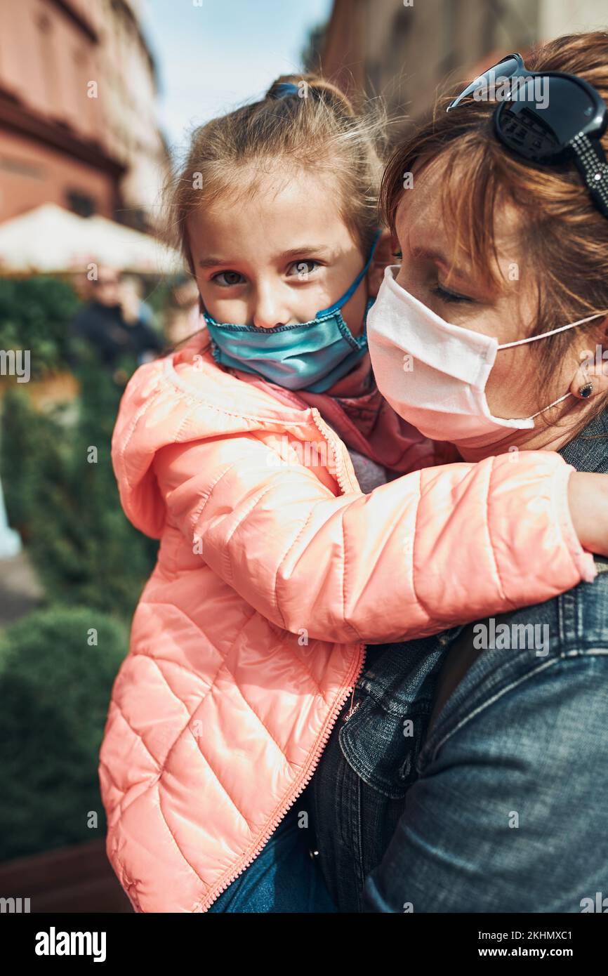 Family mother and her daughter standing in a street downtown wearing ...