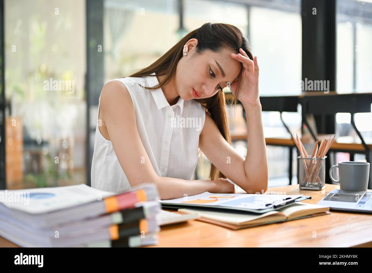 Stressed and frustrated millennial Asian businesswoman or female boss ...