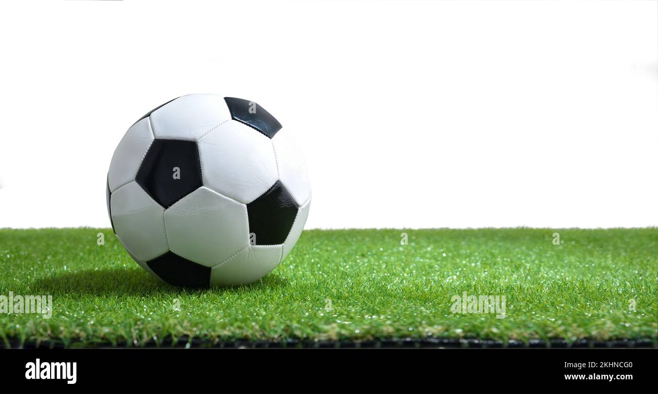 Classic soccer ball on artificial grass and white isolated background ...