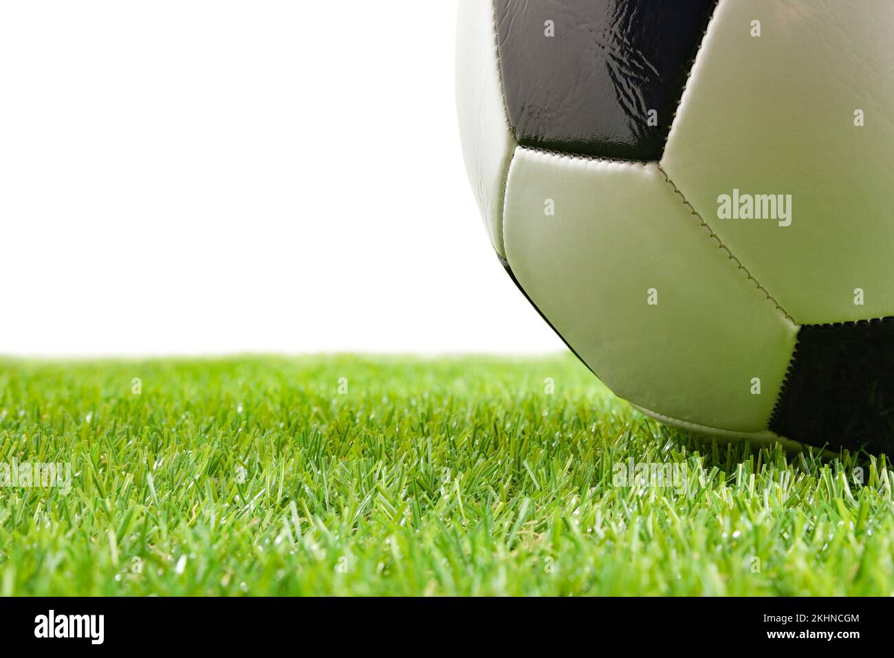 Macro of classic soccer ball on artificial grass and white isolated ...