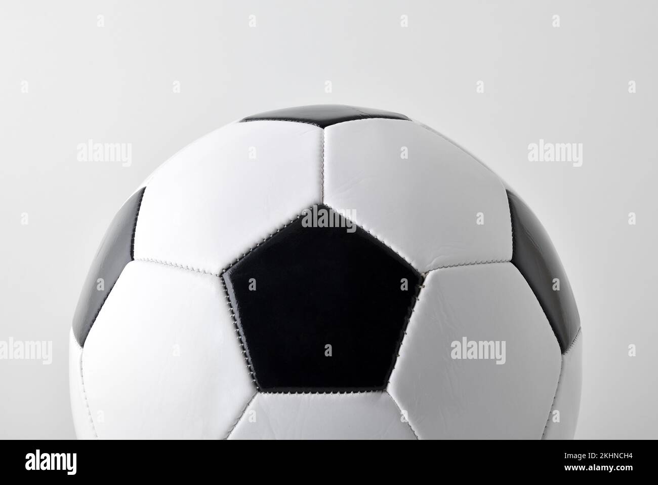 Background with closeup of half classic leather stitched soccer ball ...