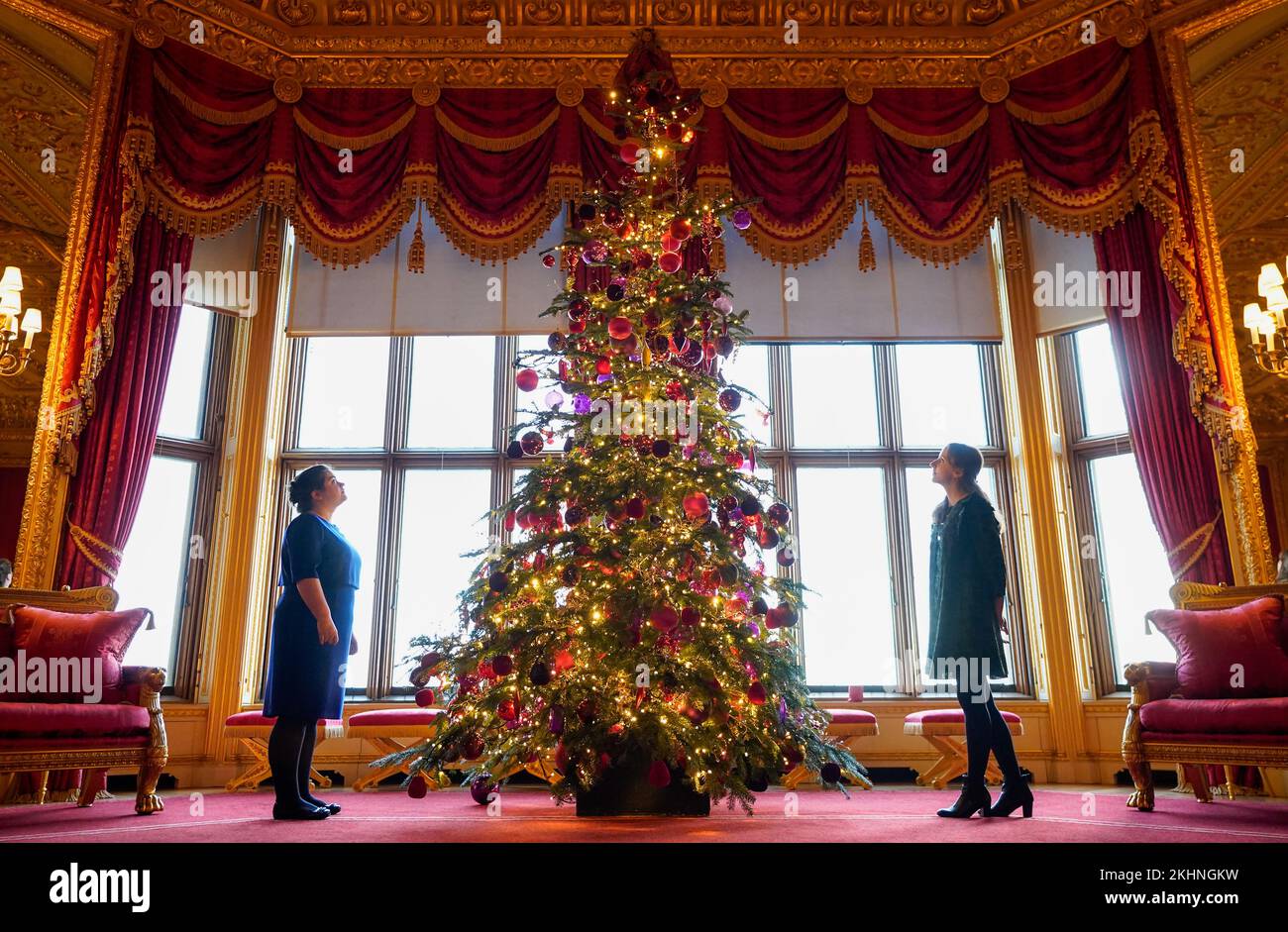 Members of the Royal Collection Trust look up at a Christmas tree on ...