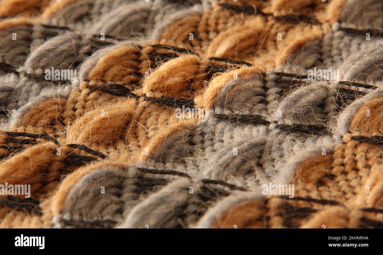 Closeup of three-dimensional waffle weave pattern in orange and grey ...