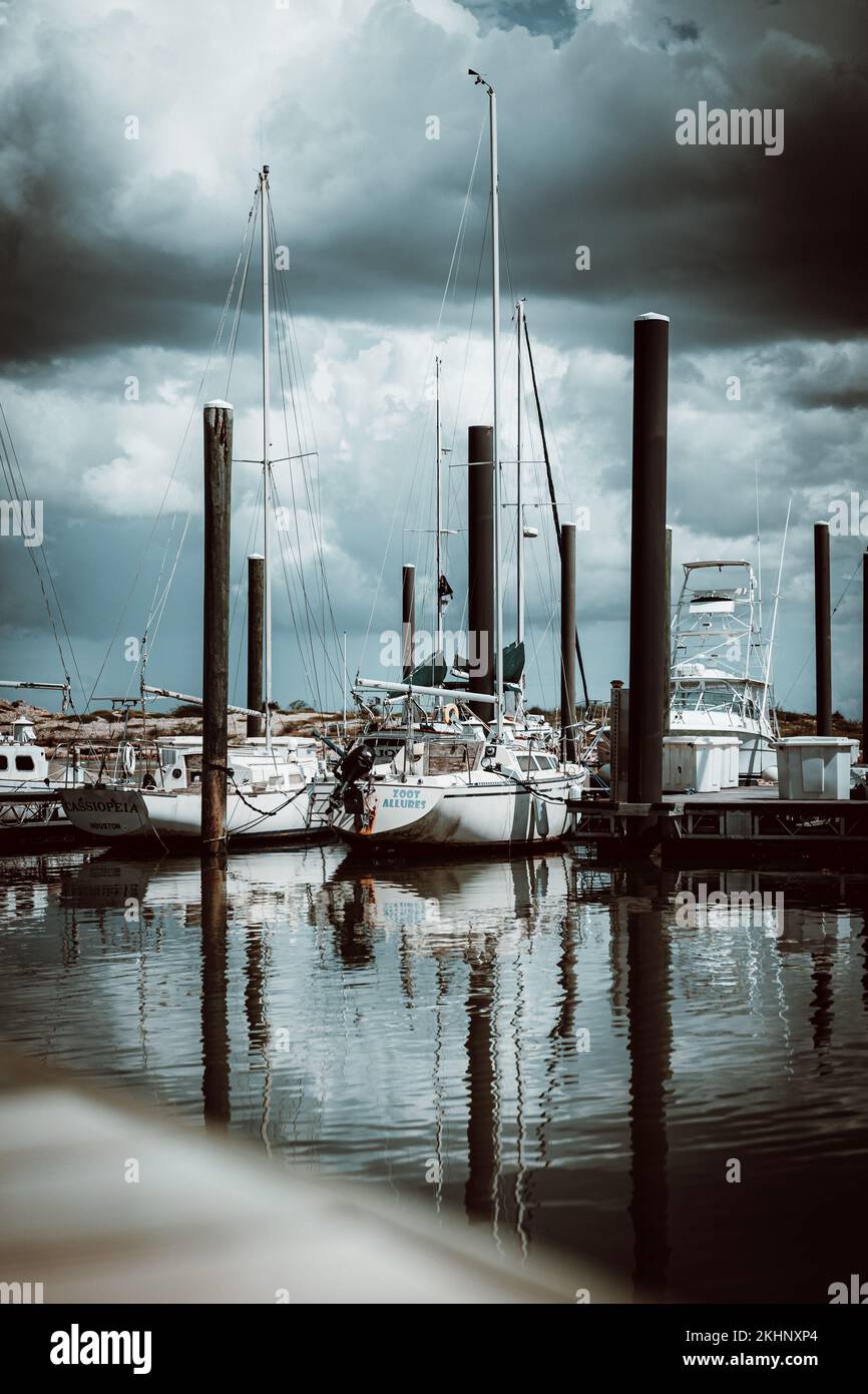 A vertical shot of boats sitting in harbor during storm in Port Lavaca ...