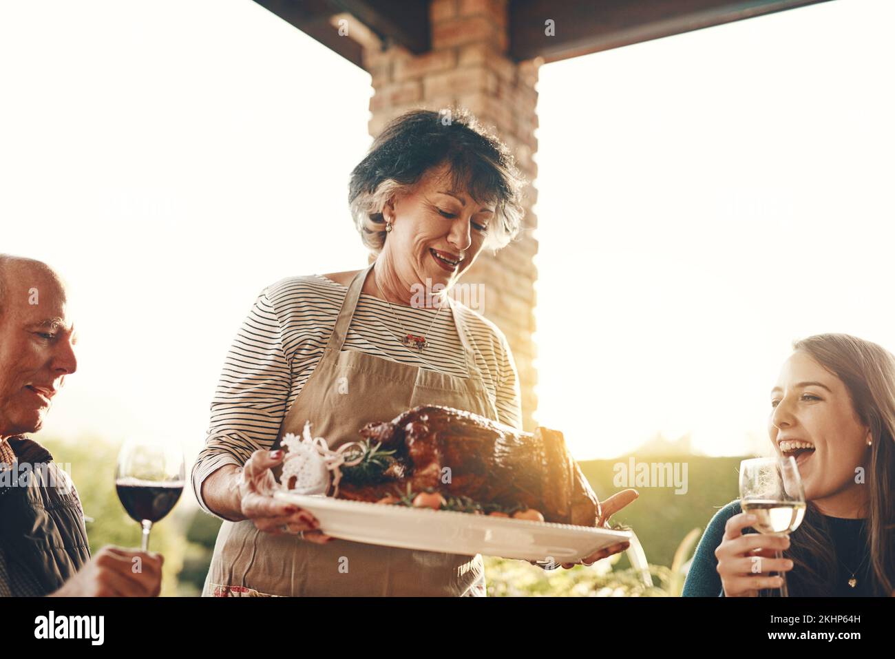 Woman, roasted chicken, turkey and food outdoor at dinner table ...