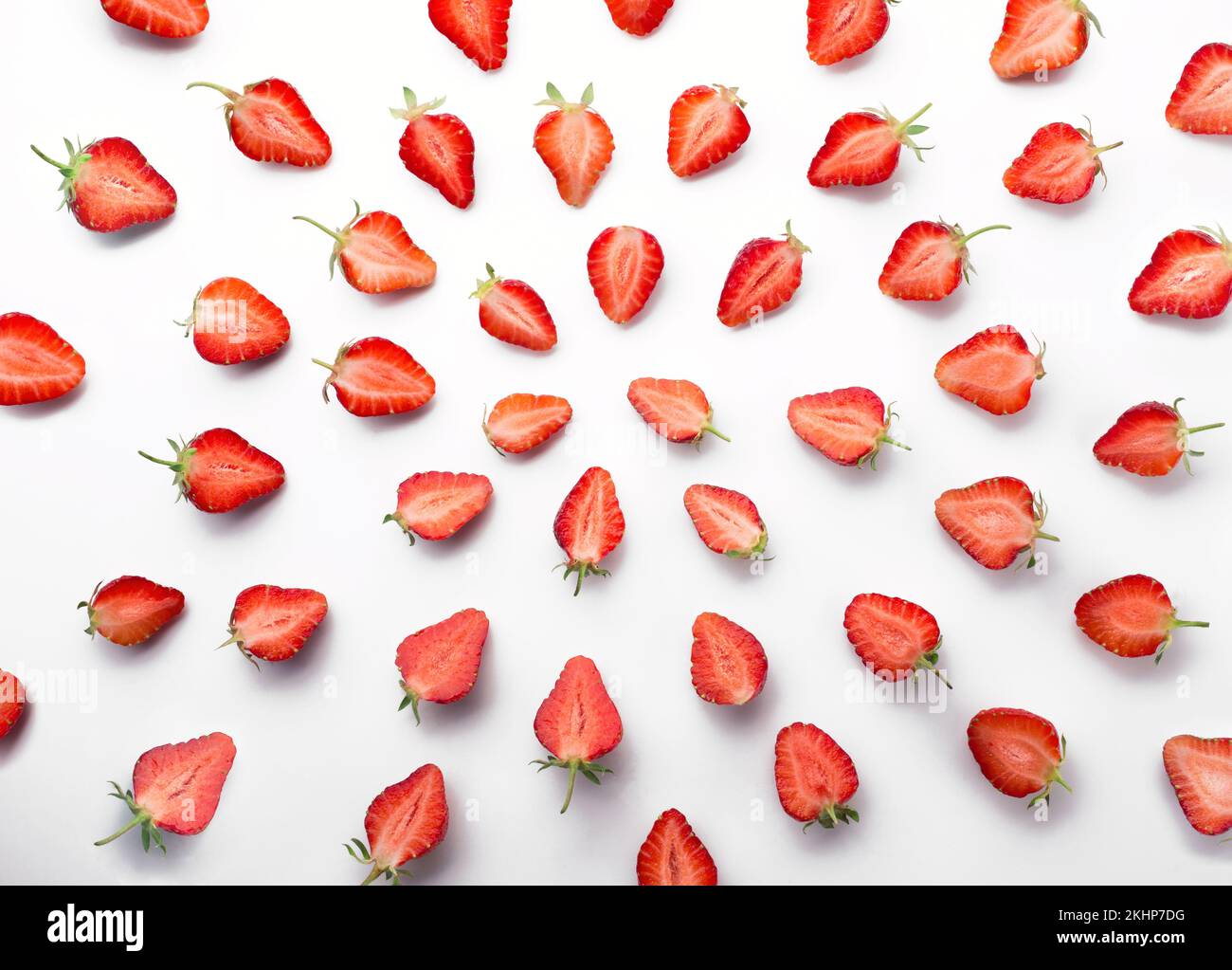 Red juicy strawberry in a cut laid out on a white background ...