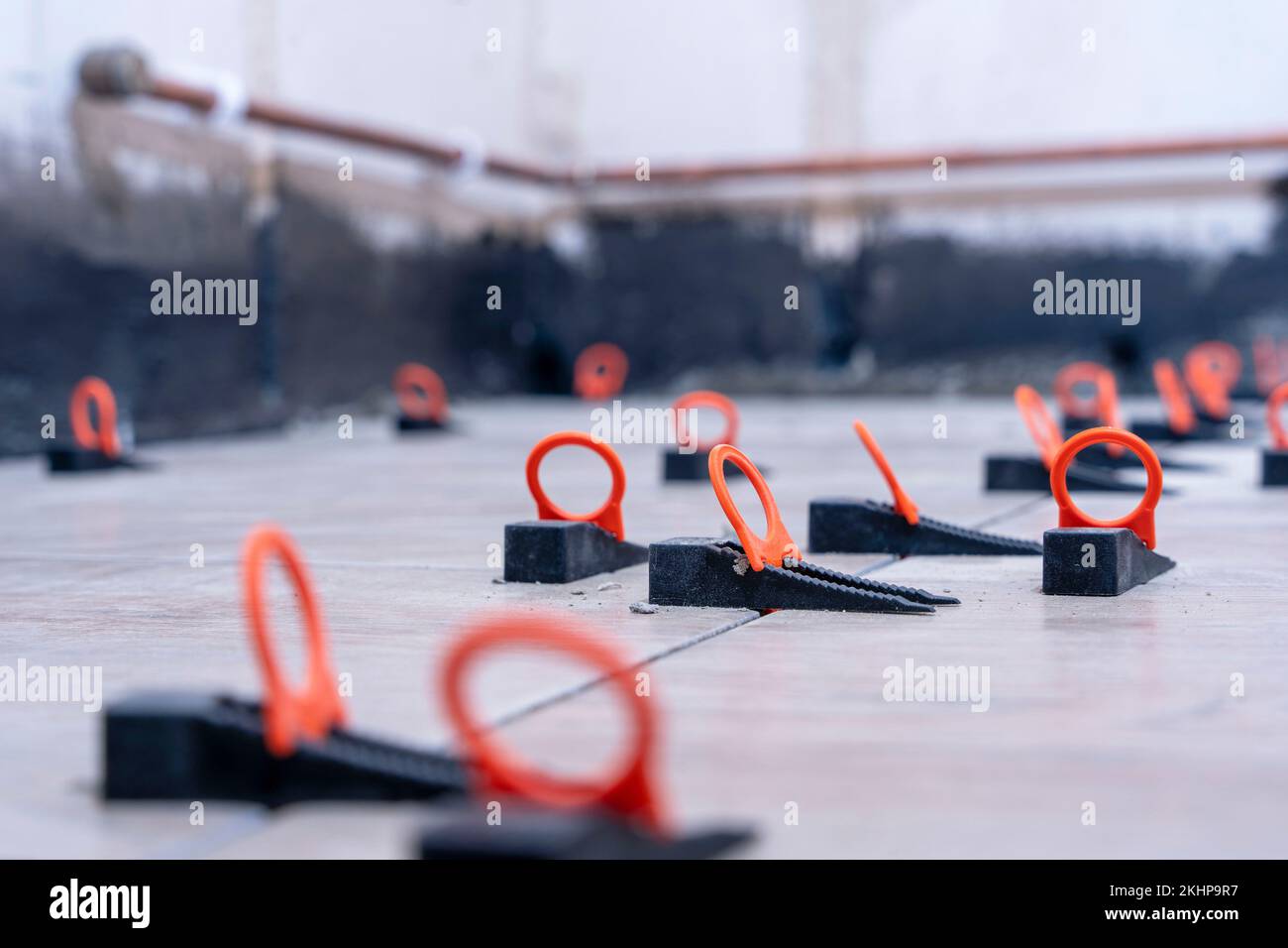 close-up of the tile alignment system holding tile in given position ...