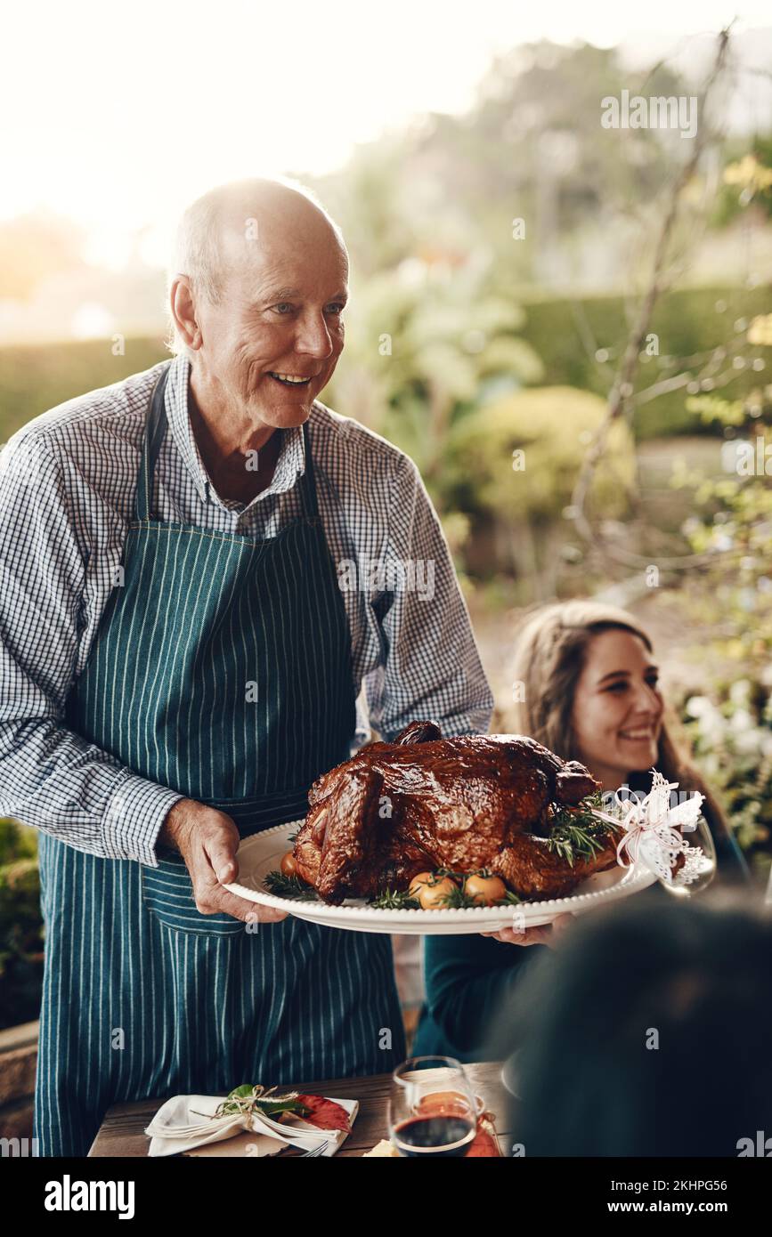Chicken, celebration and man serving lunch on Christmas holiday, family ...